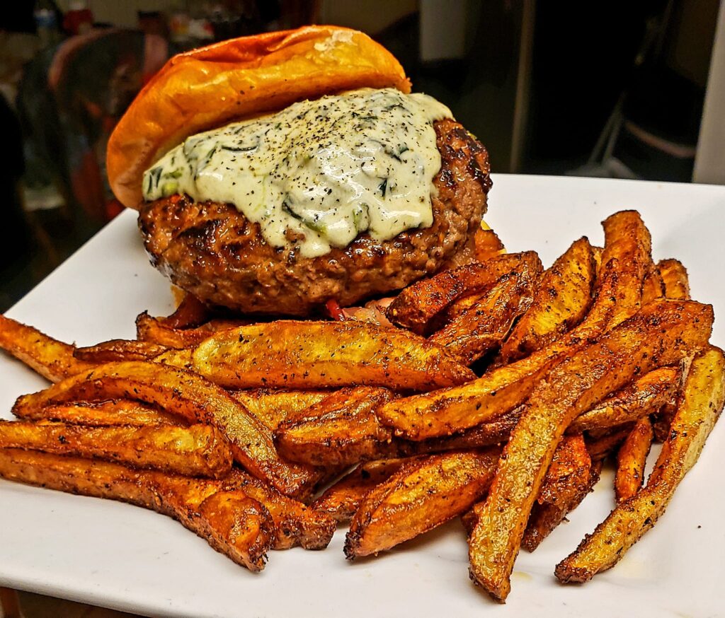 Burger with bacon, grilled onions, topped with three cheese creamed ...
